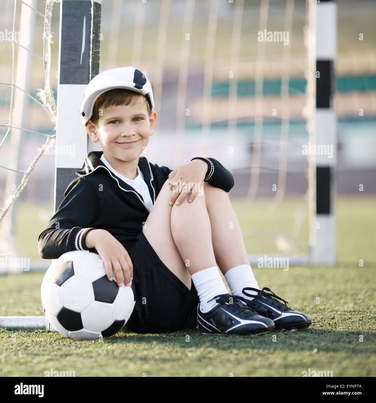 boy plays football on stadium Stock Photo - Alamy