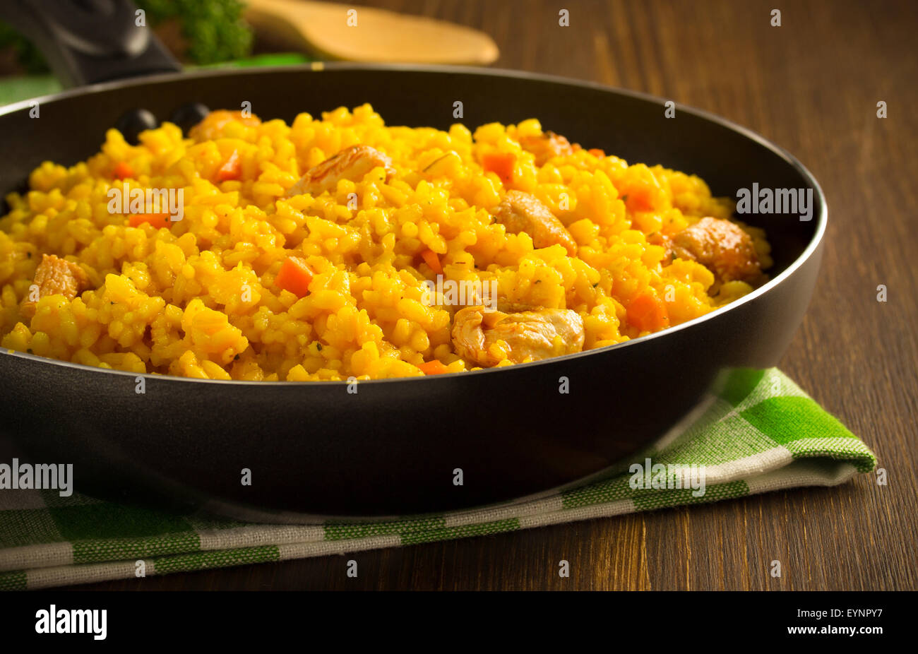 frying pan full of rice on wooden background Stock Photo - Alamy