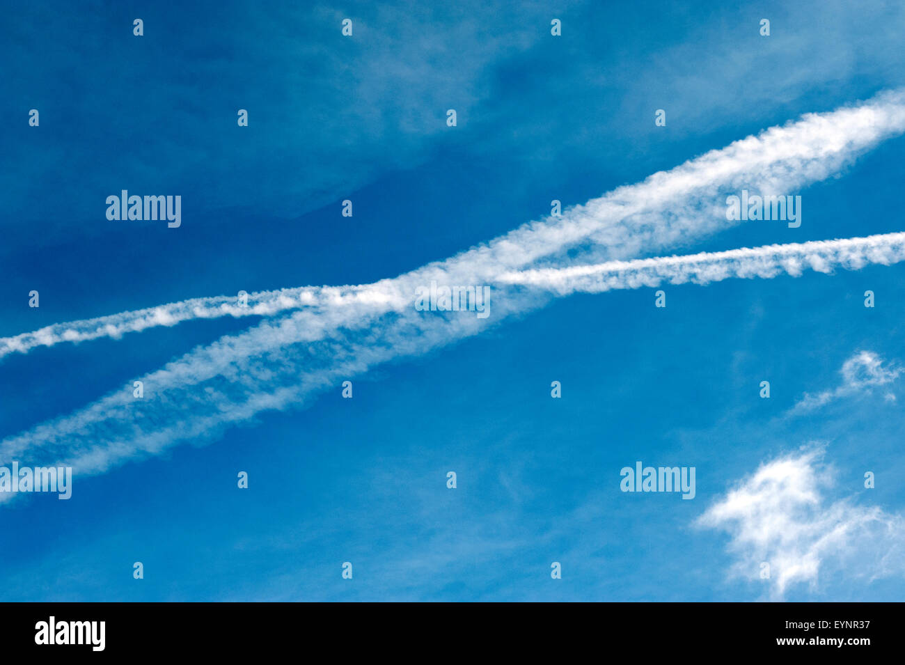 Blue sky with contrails crossing hi-res stock photography and images ...