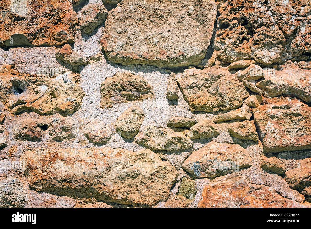 Fragment of the ancient stone wall executed from stones of various form ...