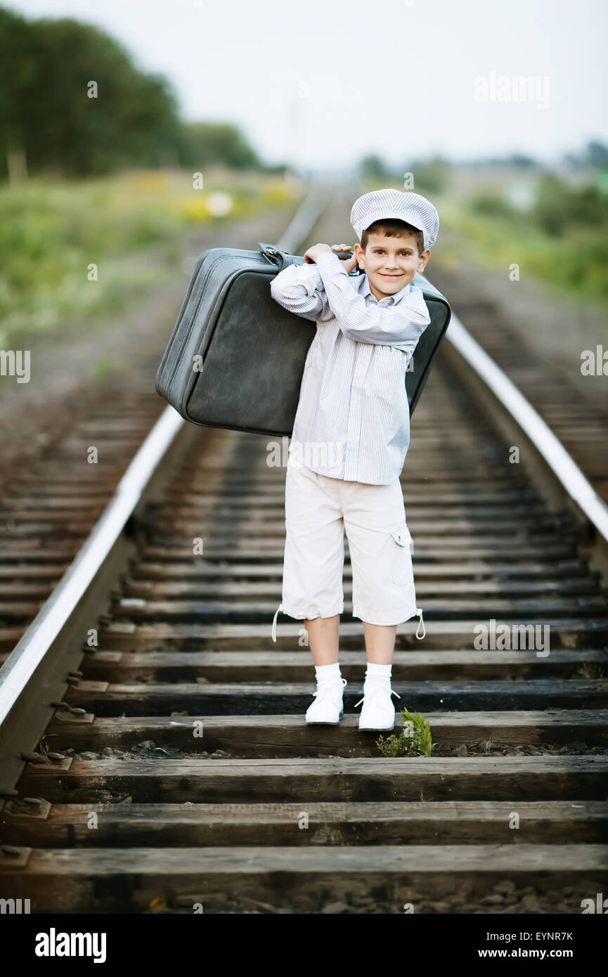 boy with suitcase on railroad Stock Photo - Alamy