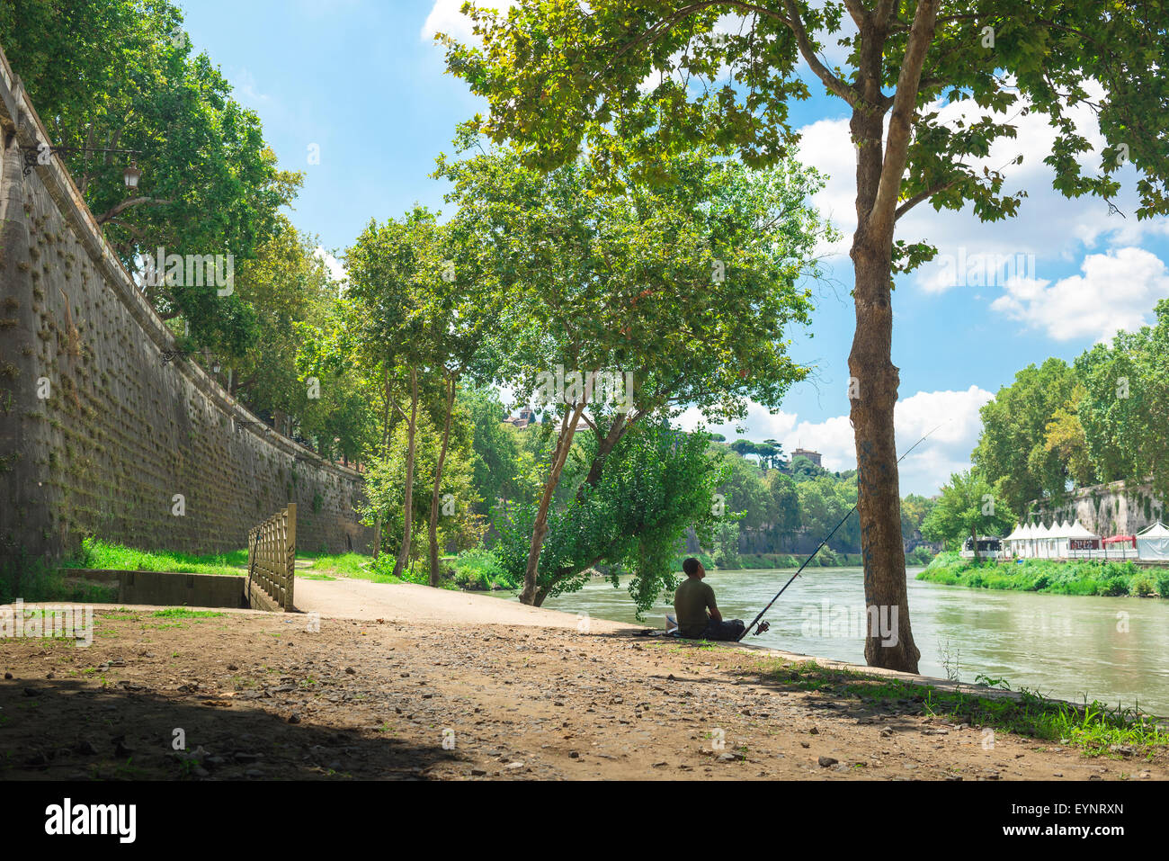 Man fishing River Tiber Rome, view in summer of a man fishing beside ...