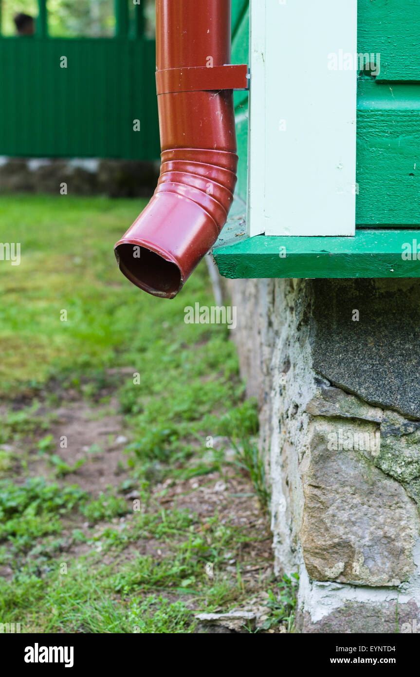 Corner of building with red metal drainpipe, architectural detail Stock ...