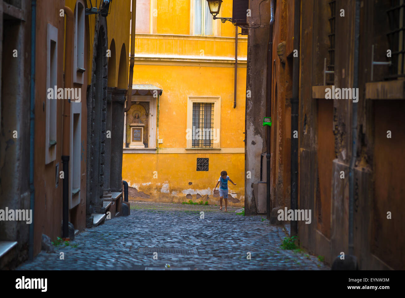Rome jewish quarter, a child runs into a narrow street in the Sant ...