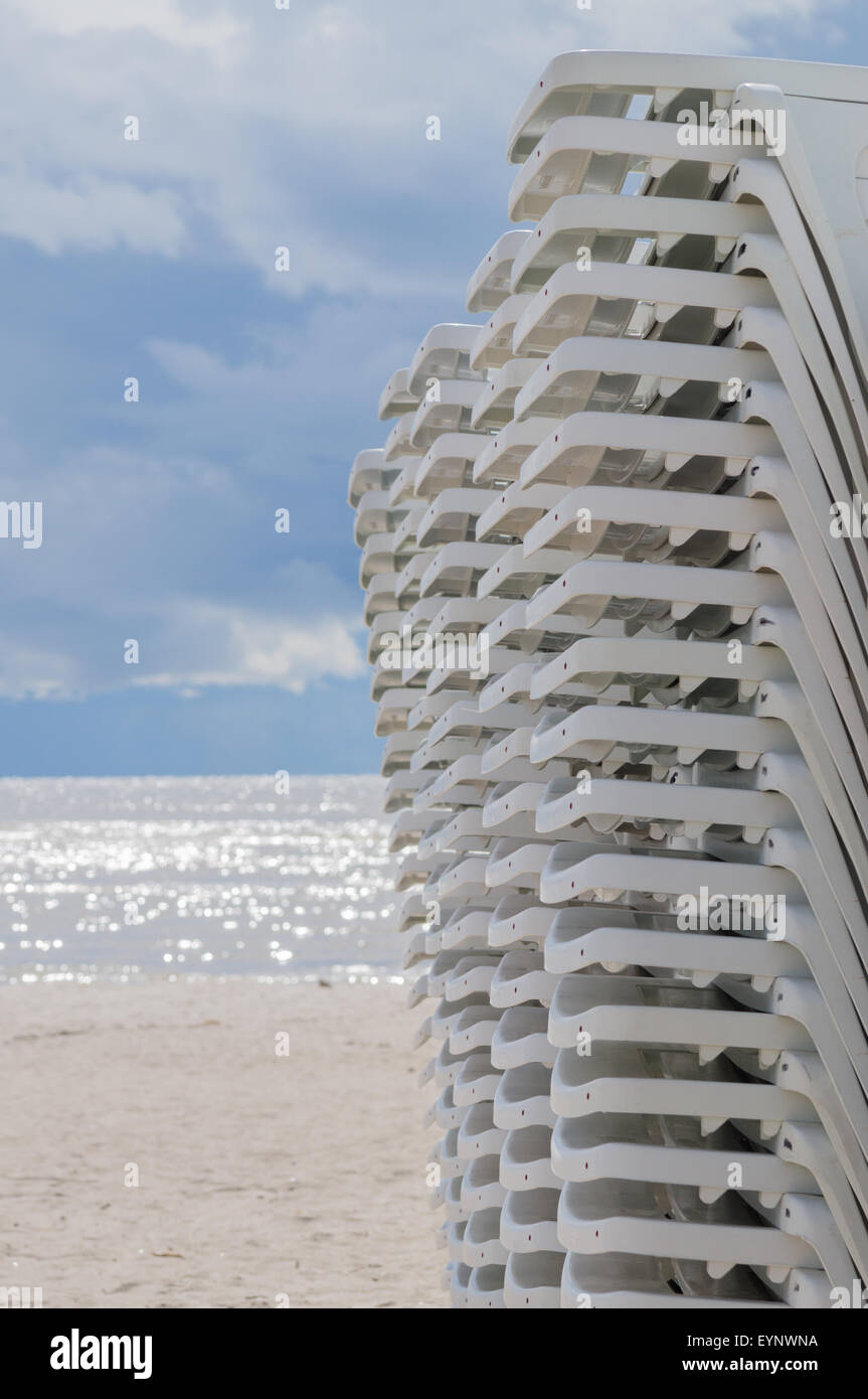 Stacked sun loungers on the beach before storm Stock Photo - Alamy