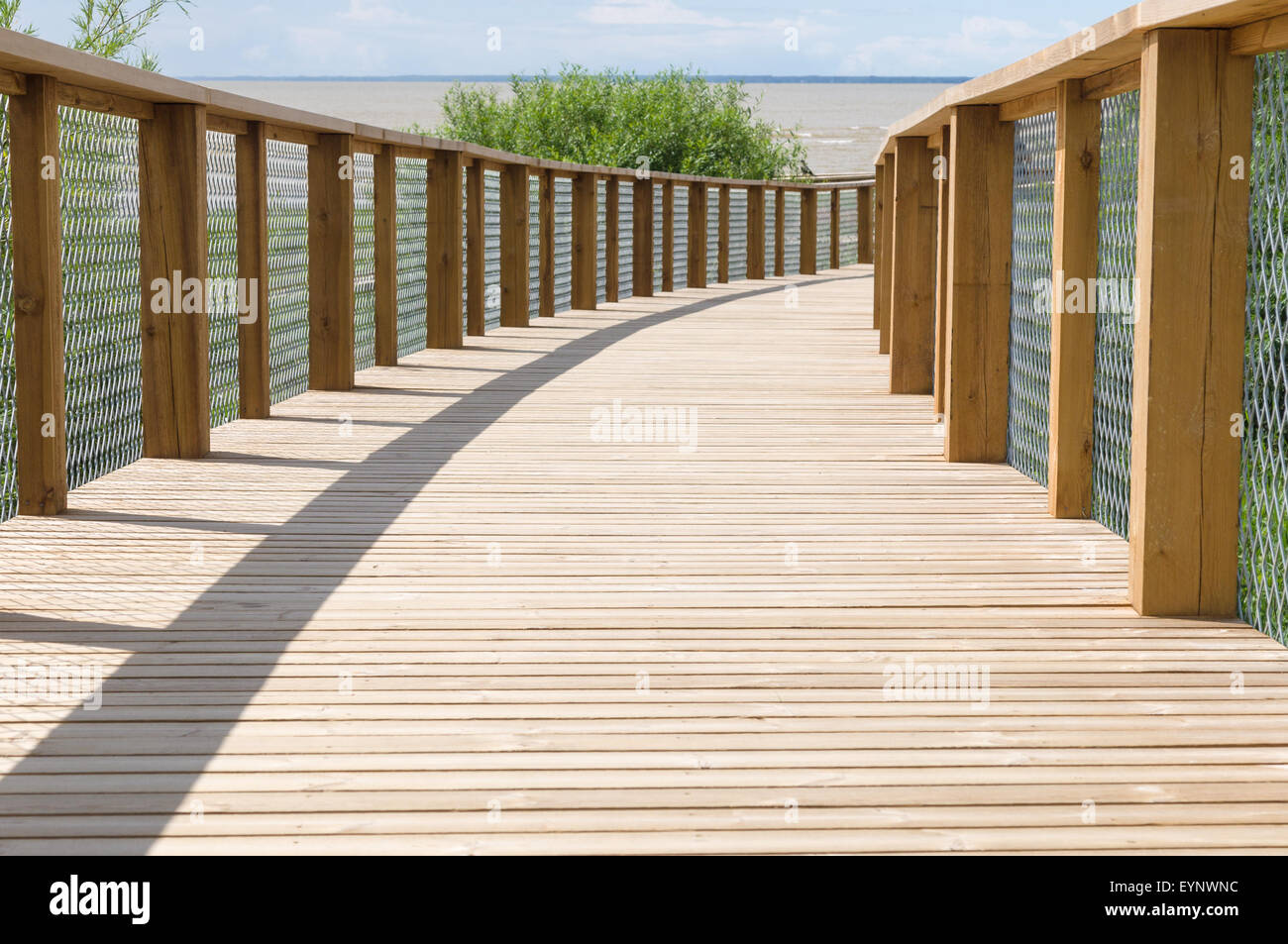Wooden plank path with safety fence leading to the sea shore Stock ...