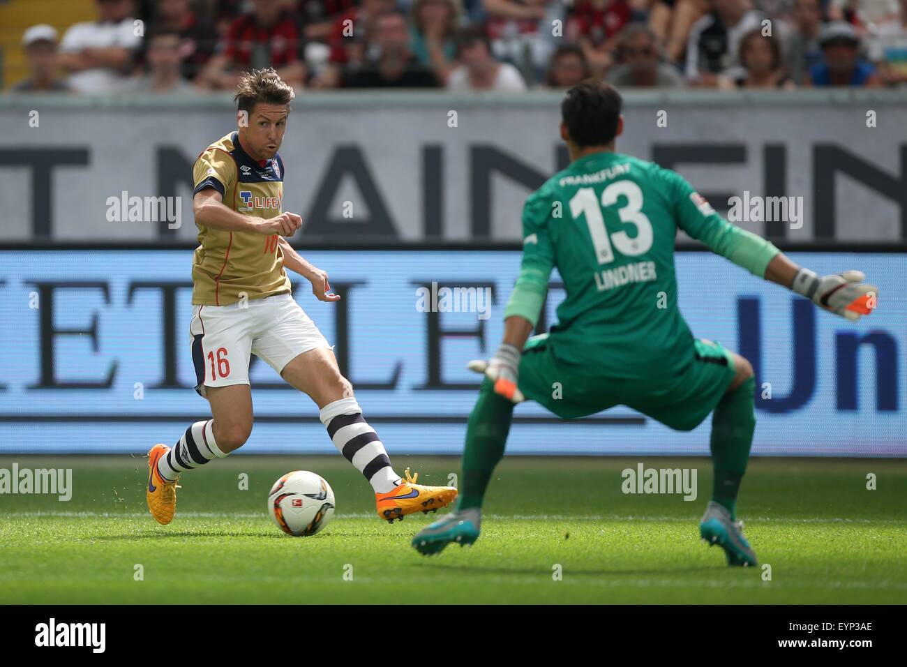 Frankfurt's goalkeeper Heinz Lindner (R) and Tokyo's Nathan Burns (L ...