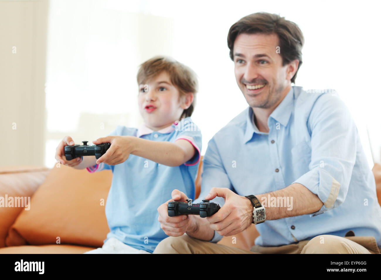 father and son play video game Stock Photo - Alamy