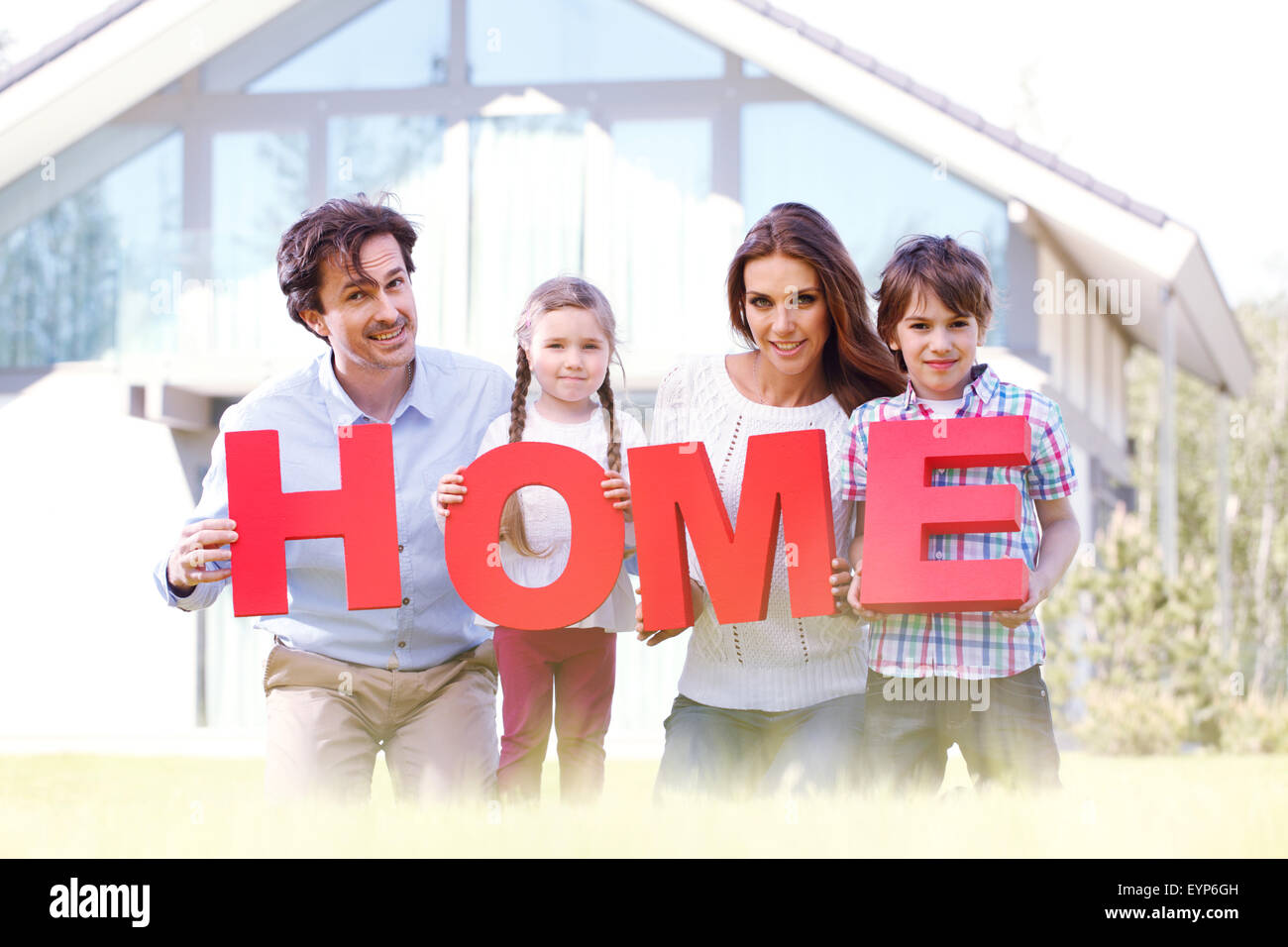 family holding home letters Stock Photo - Alamy