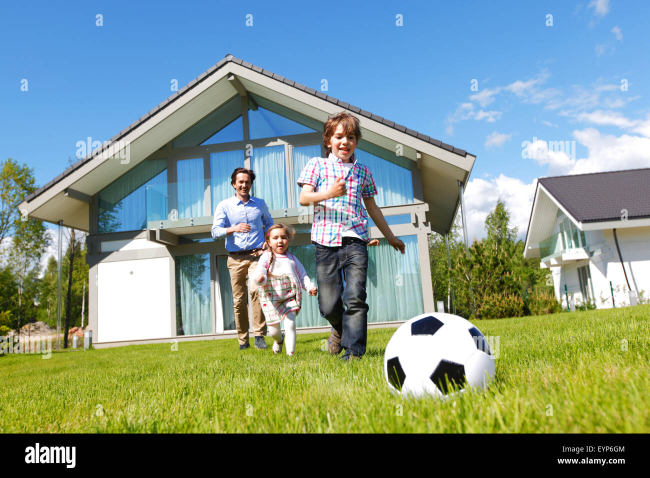 family playing football Stock Photo - Alamy