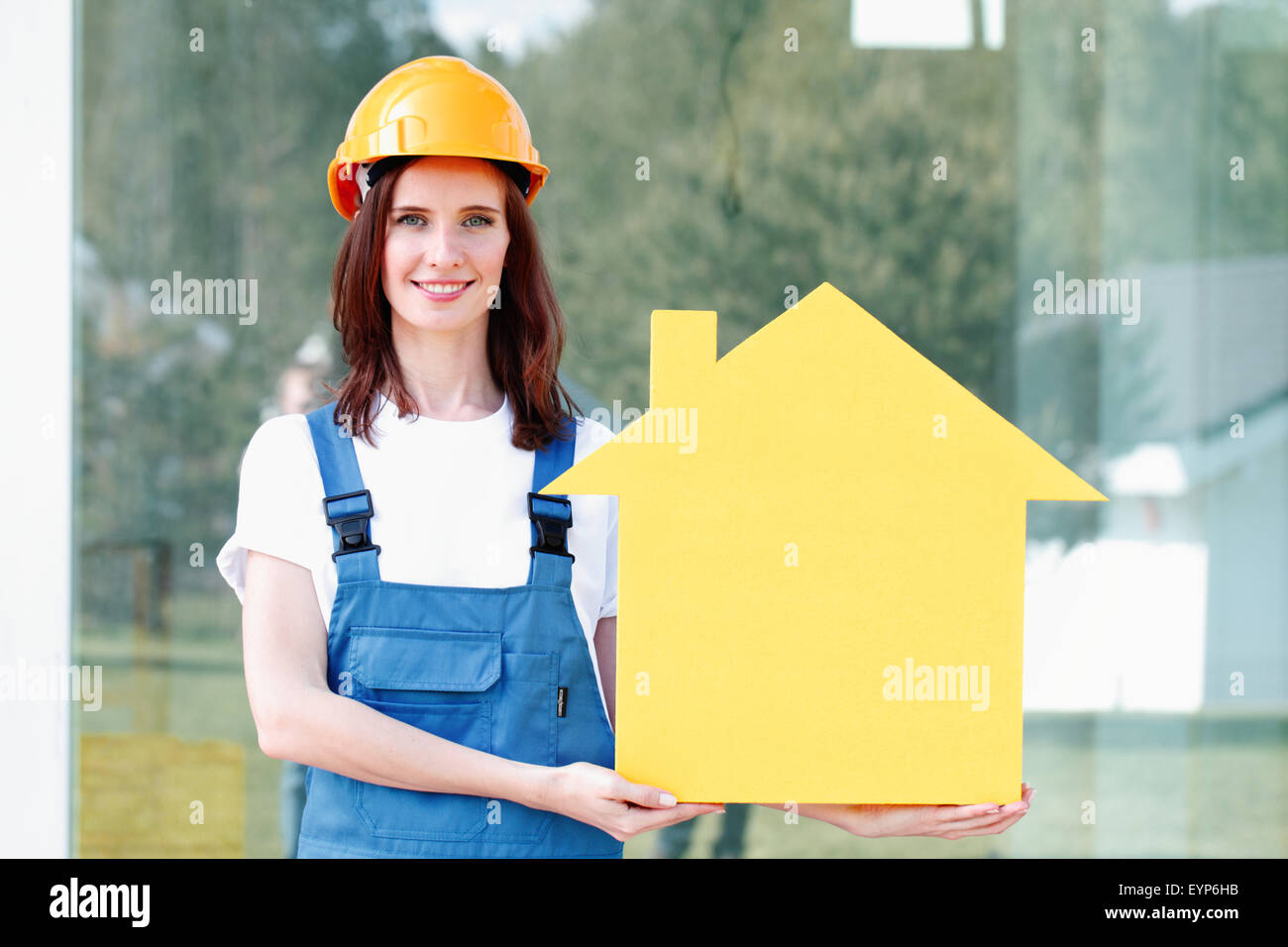 workman and house symbol Stock Photo - Alamy