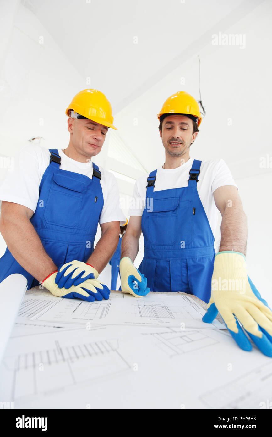 workmen looking at house design Stock Photo - Alamy