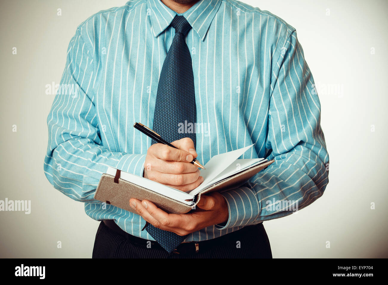 Office staff writes notes in the diary report Stock Photo - Alamy