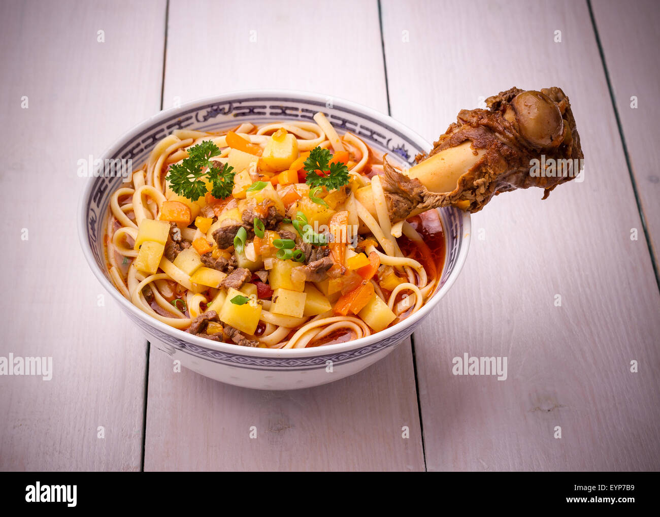 Uzbek noodle soup Lagman with large bone, top view Stock Photo - Alamy