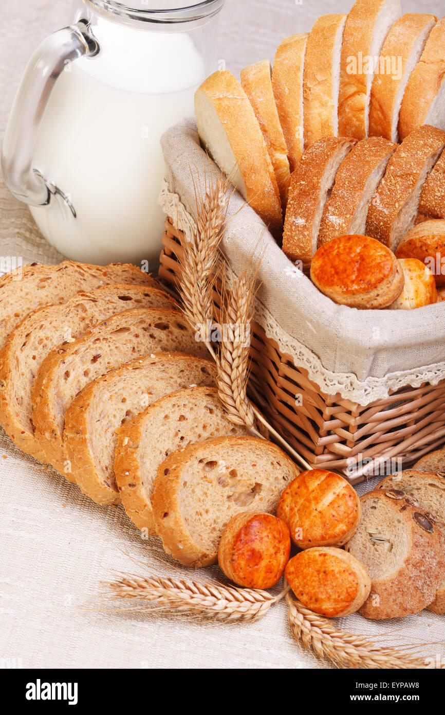 Assorted bakery products sliced, arranged in small basket and around ...