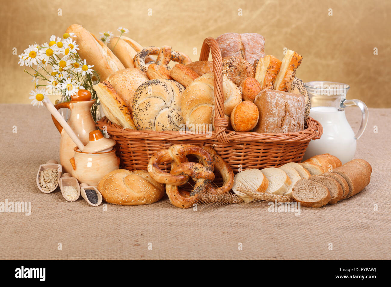 Composition of various baked products in basket on rustic background ...