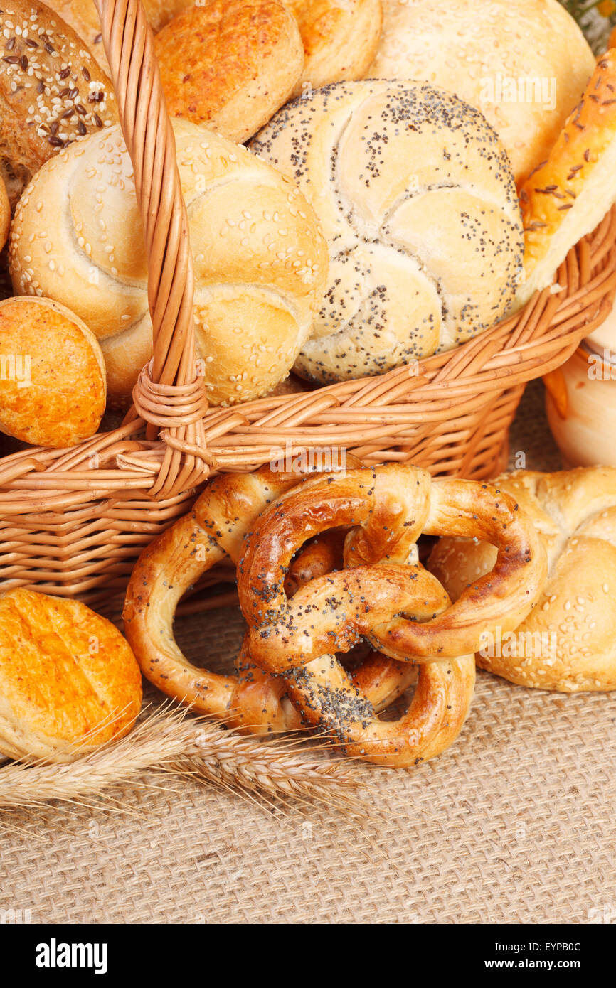 Composition of various baked products in basket on rustic background ...