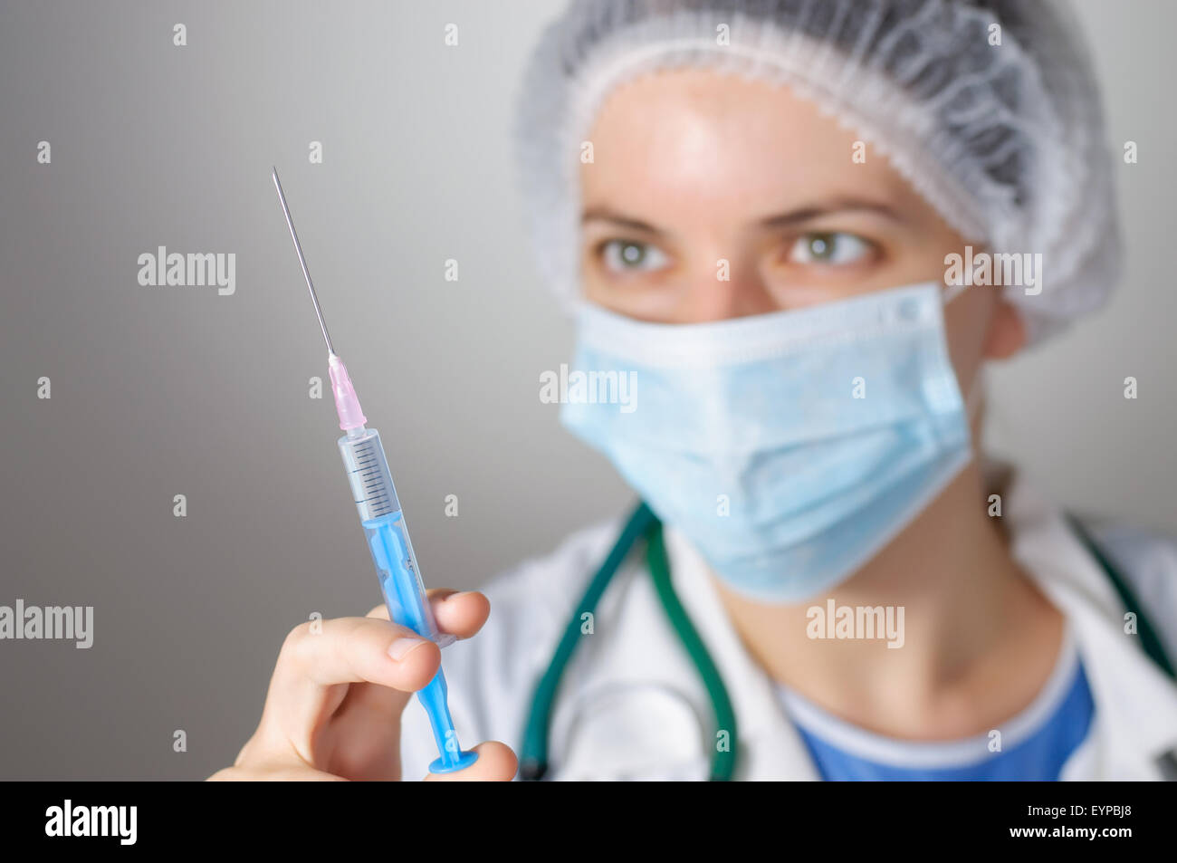 Female doctor with syringe and face mask Stock Photo - Alamy