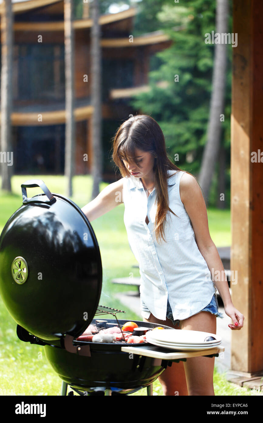 woman cooks on grill Stock Photo - Alamy
