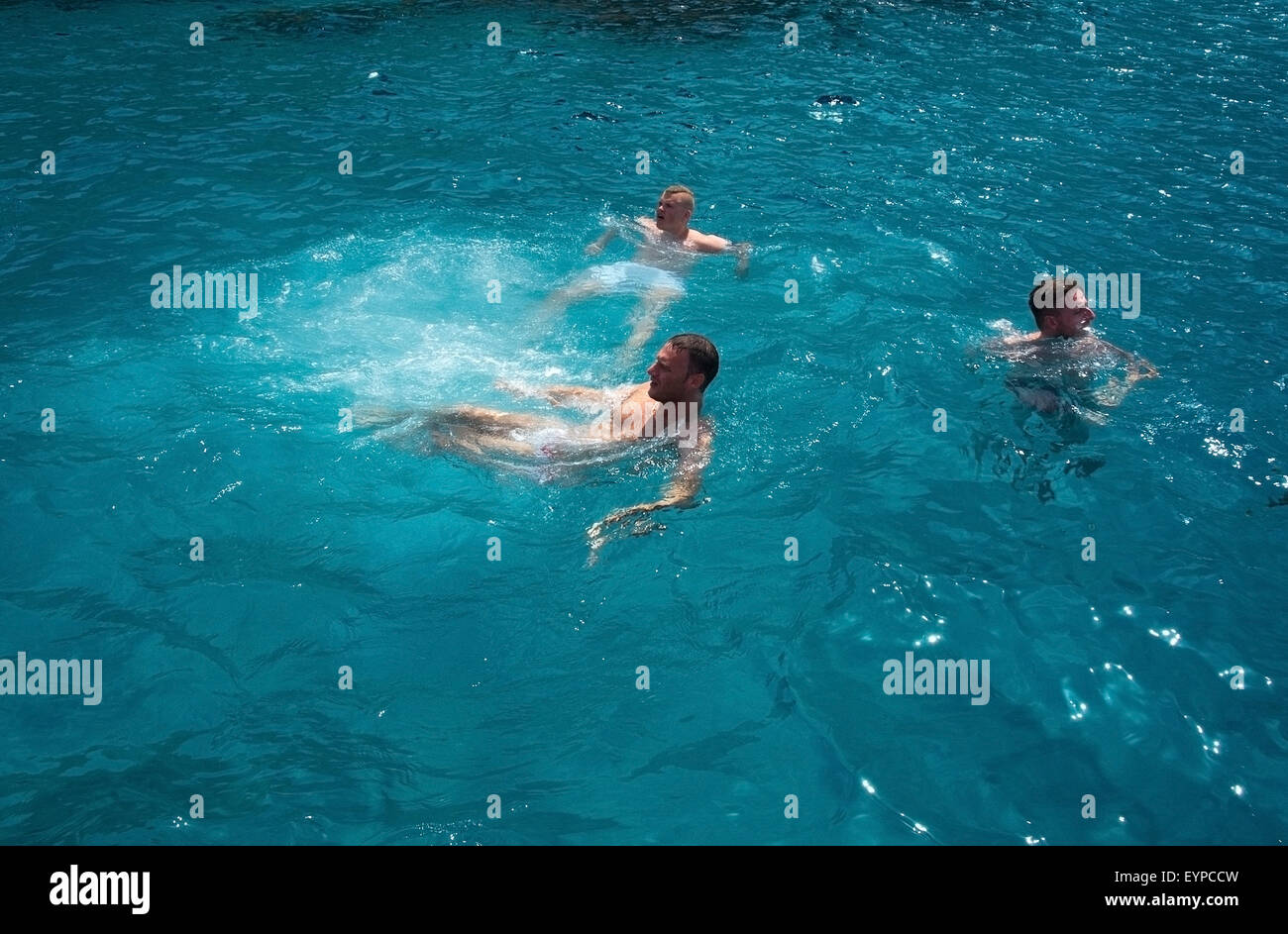 People splash and swim in turquoise Mediterranean water closeup on a ...