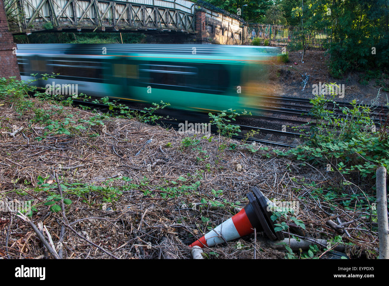 Road bollards and general rubbish on a train track with a train ...