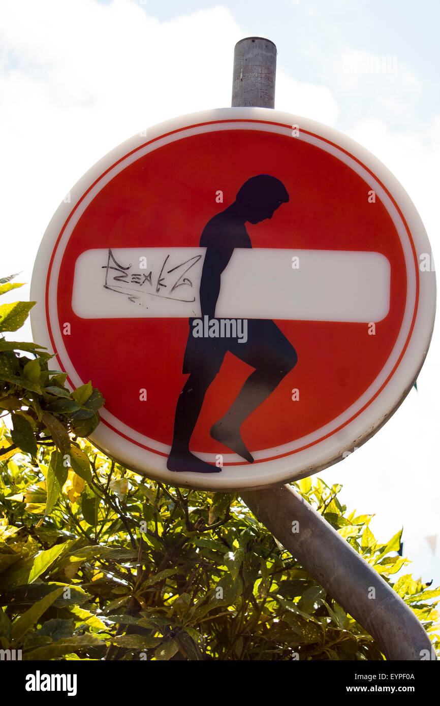 Graffiti on a road sign. No entry sigh made to represent a surfer ...