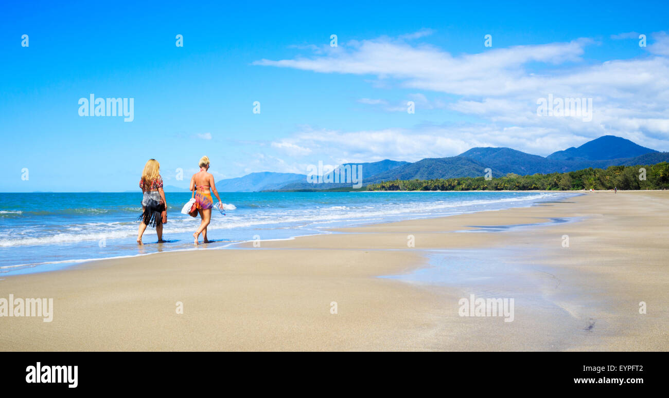 Young woman walking down beach hi-res stock photography and images - Alamy