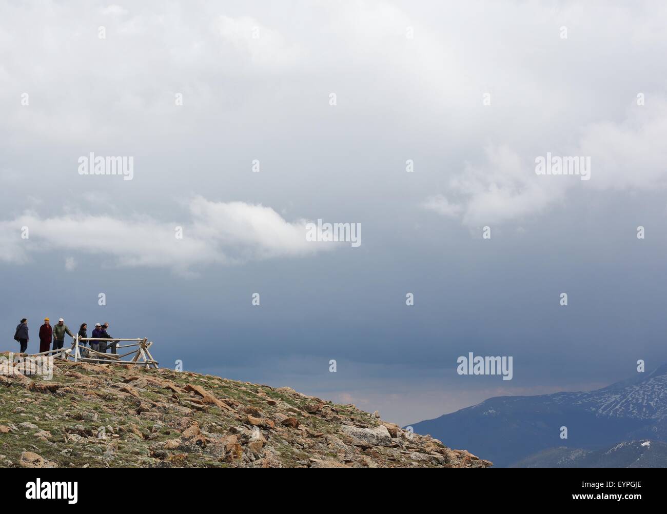 People standing at a scenic viewing area at Rocky Mountain National ...