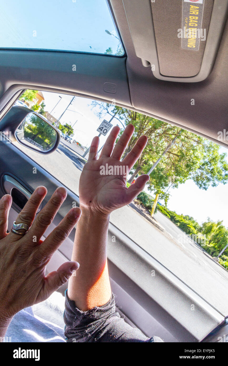A woman passenger gestures with her hands while having a conversation ...