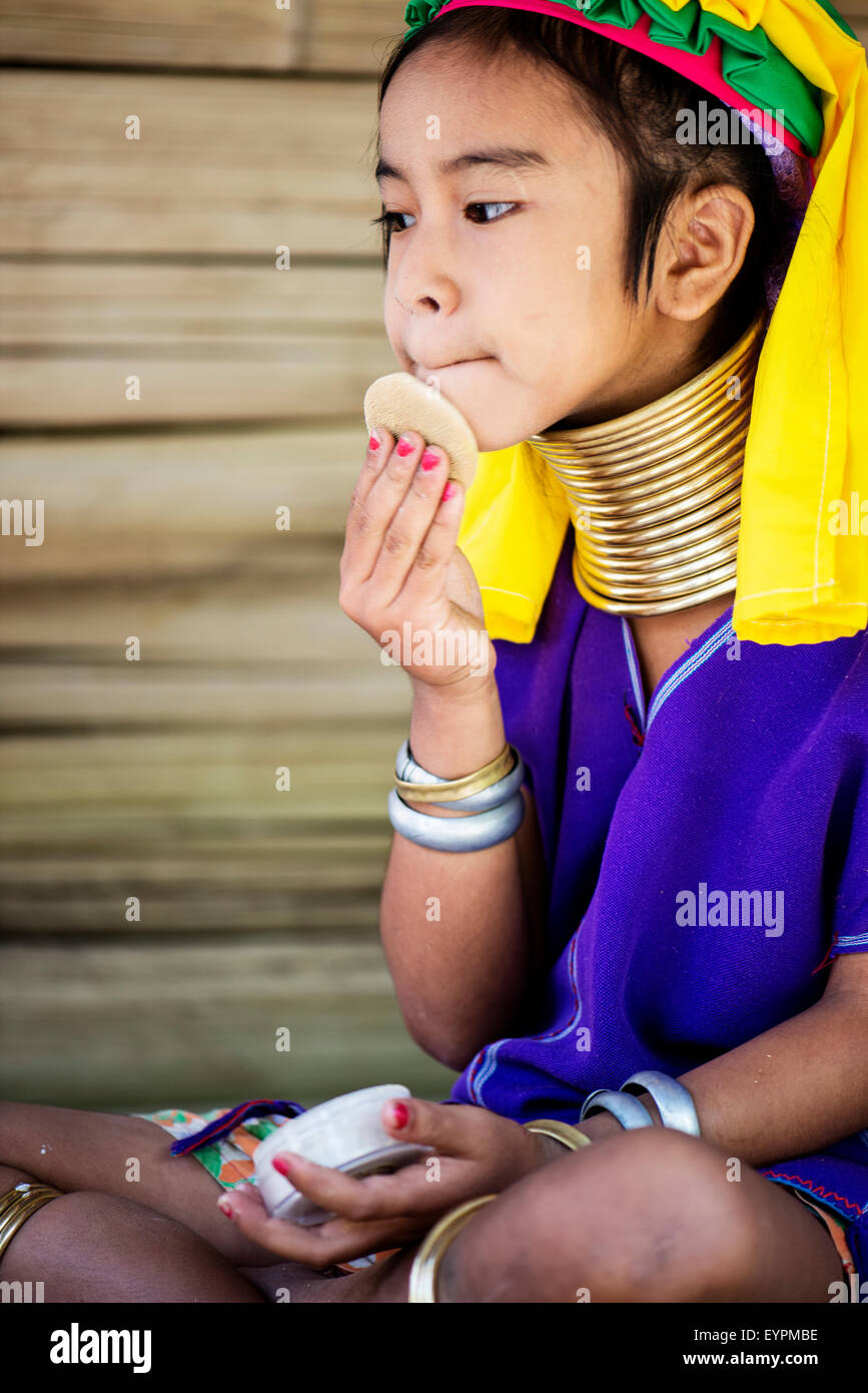 Young Kayan girl applies her make up in Chiang Mai, Thailand, Asia ...