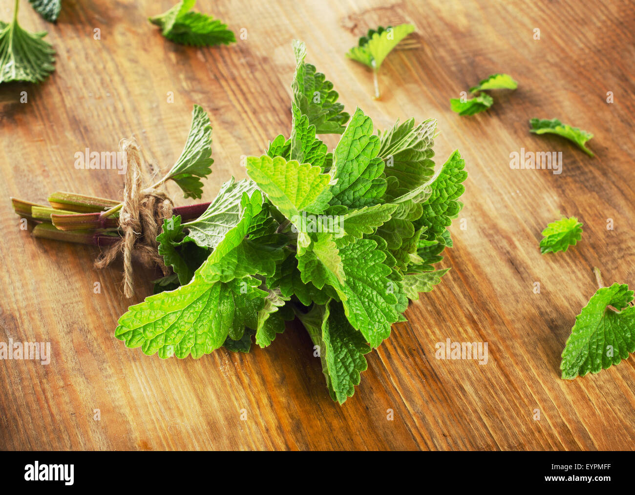 Bunch of Fresh mint leaves on rustic wooden board. Selective focus ...