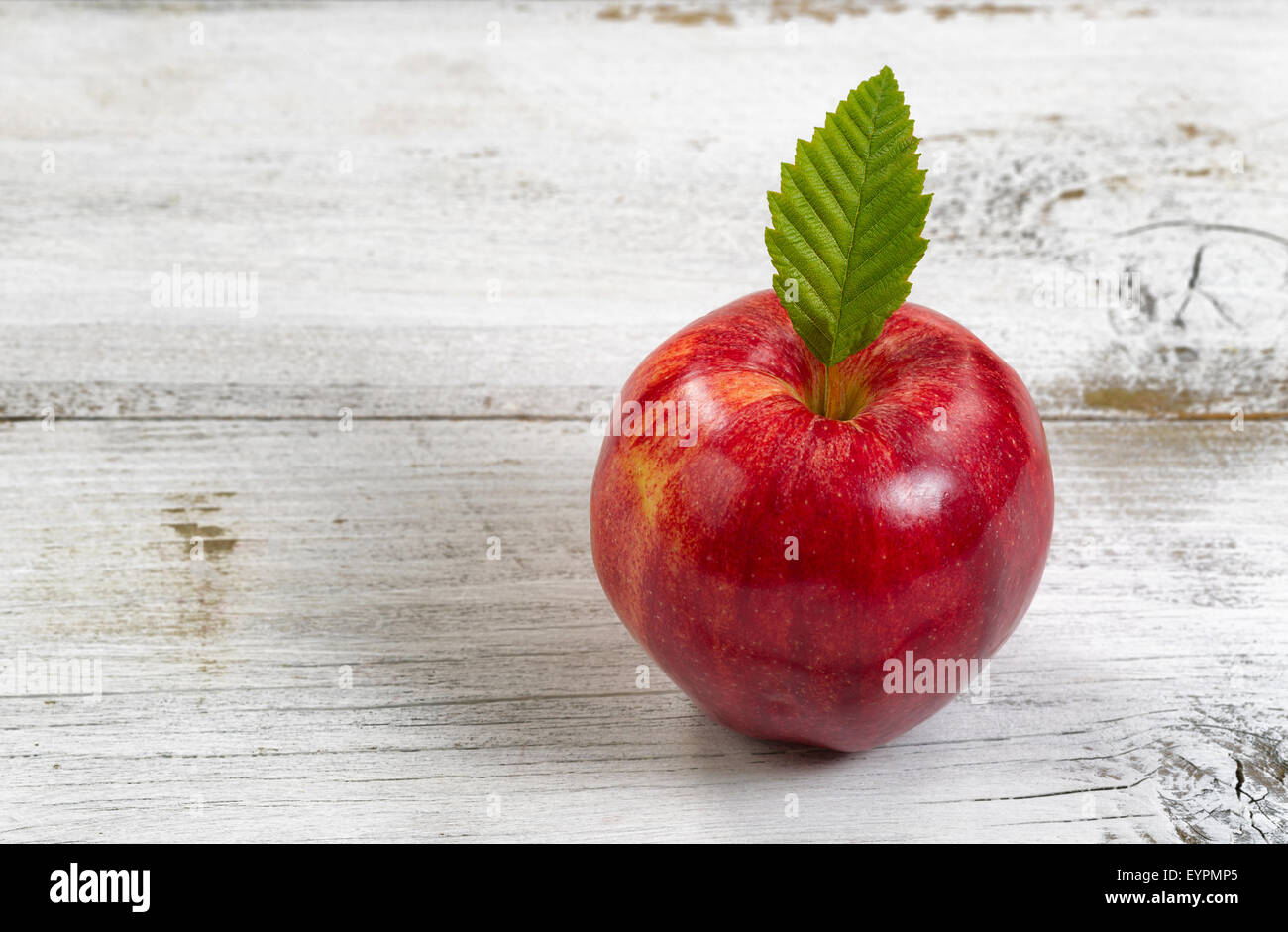 Close up of a fresh whole red apple on rustic white wood Stock Photo ...