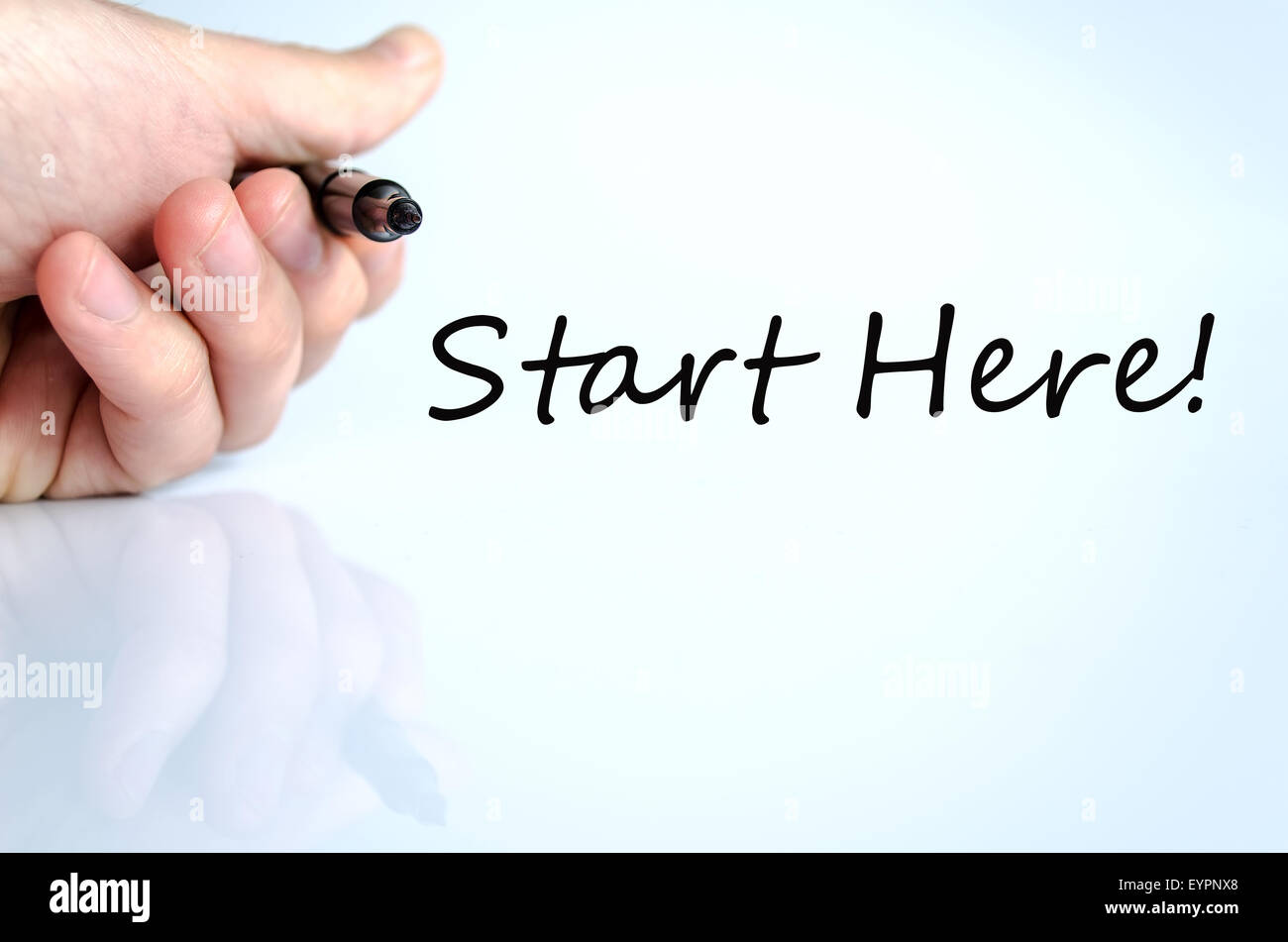 Start here hand concept isolated over white background Stock Photo - Alamy