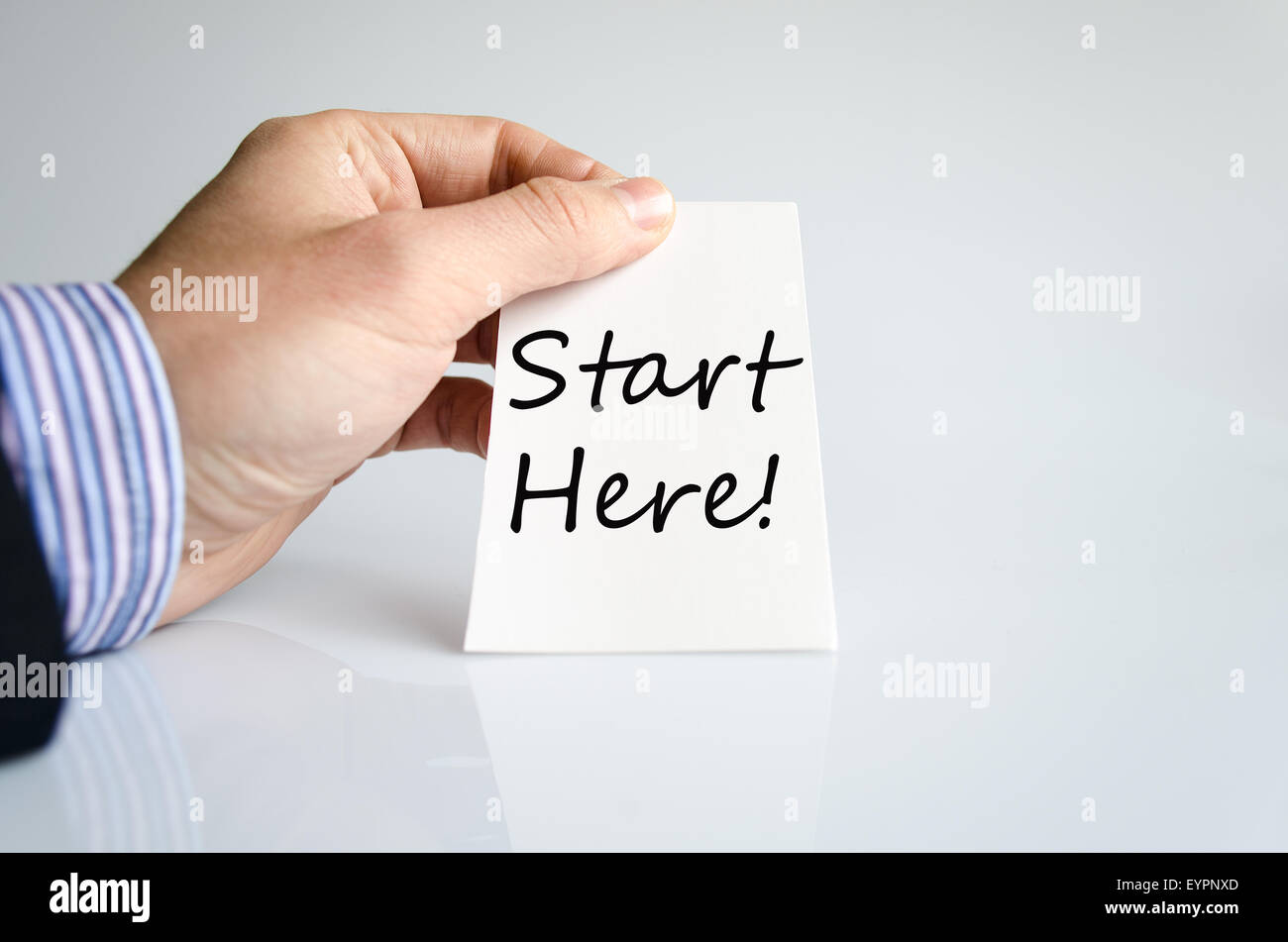 Start here hand concept isolated over white background Stock Photo - Alamy