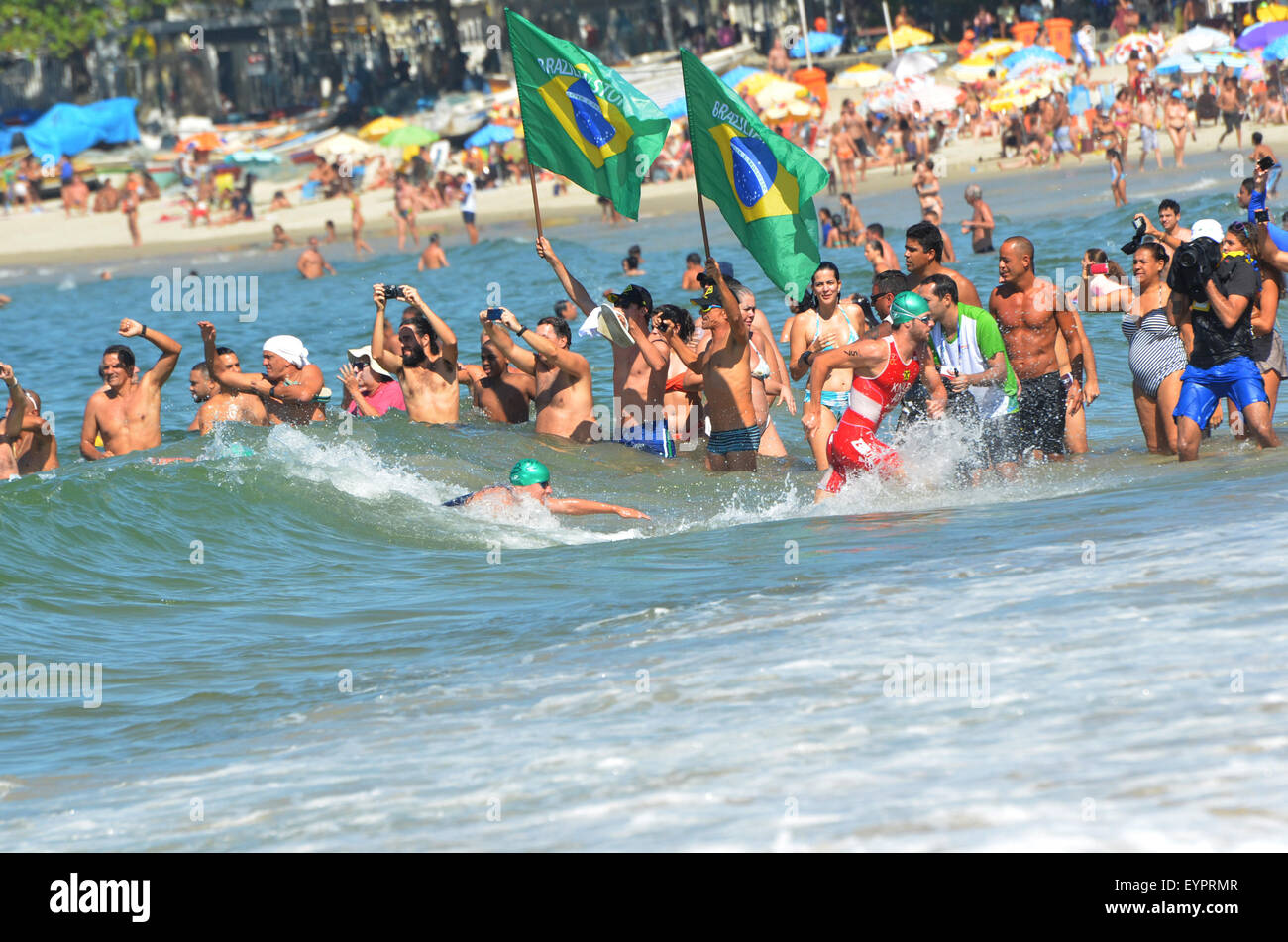 Rio de Janeiro, Brazil. 02nd Aug, 2015. Beach-goers watch athletes in ...