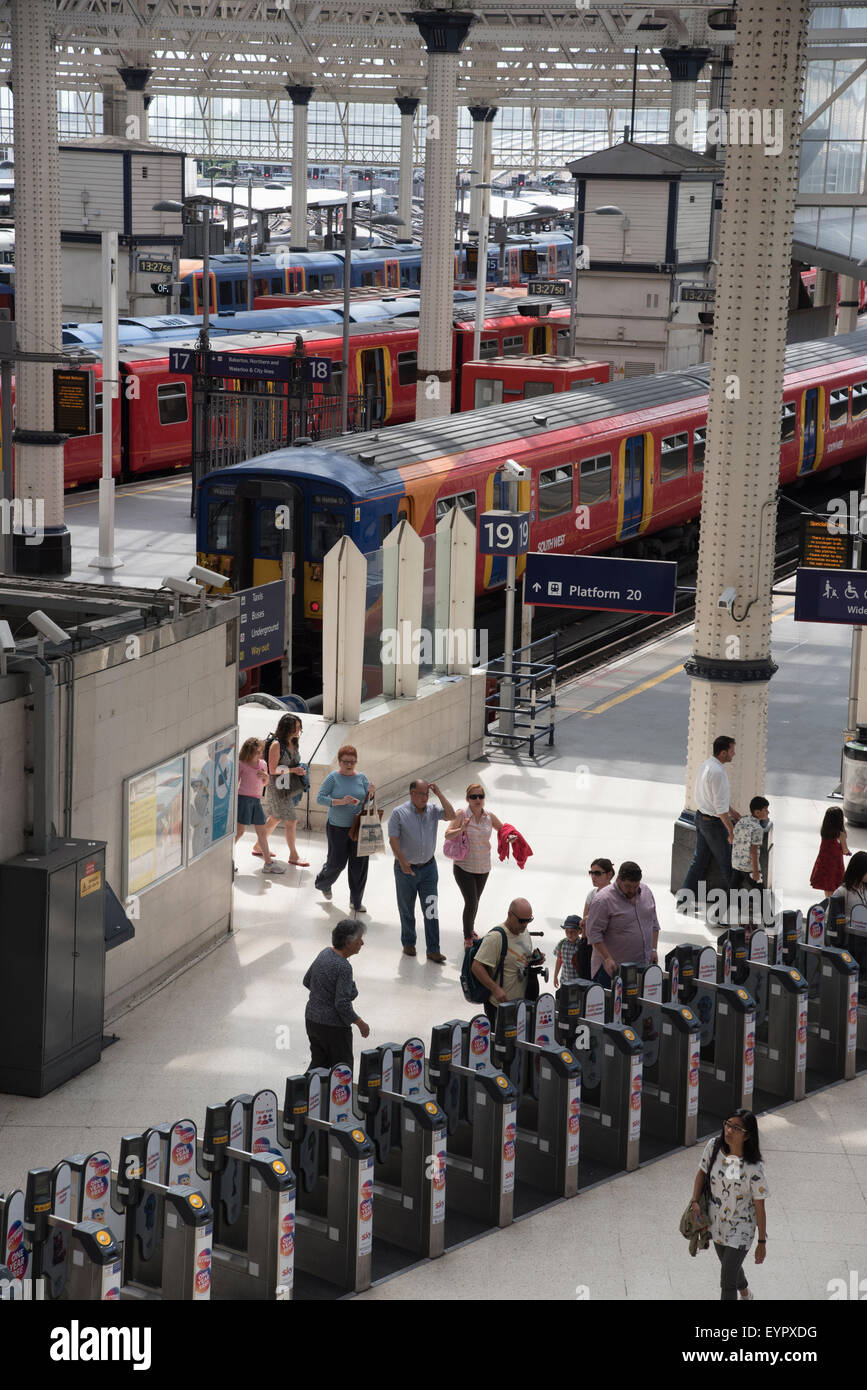 Trains at Waterloo Station central London UK and platform exit barriers ...