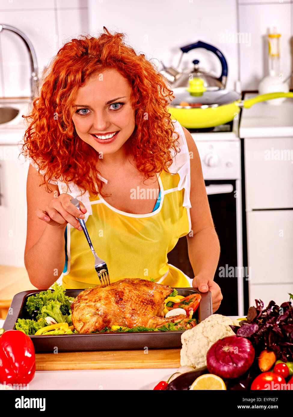 Woman cooking chicken at kitchen Stock Photo - Alamy
