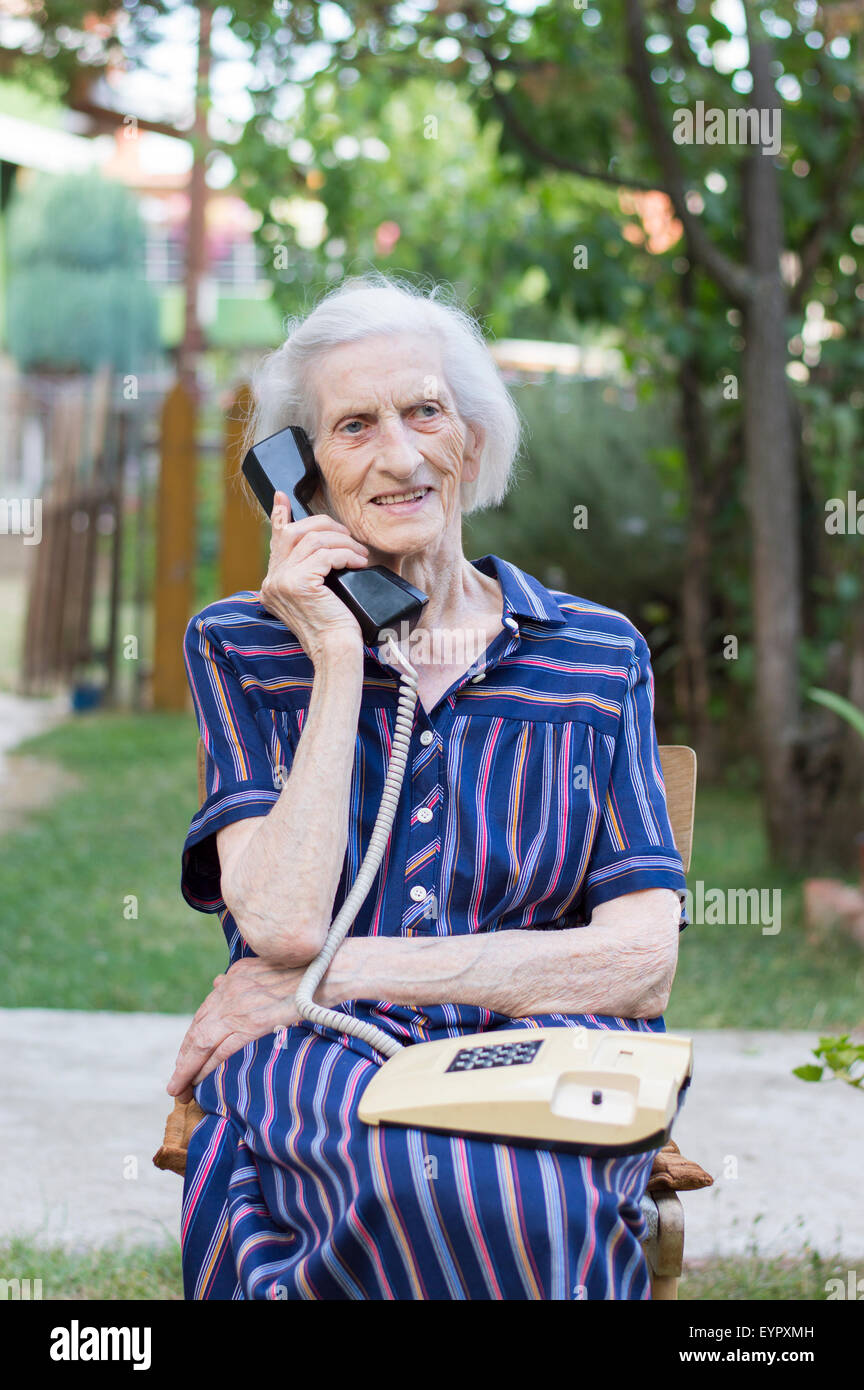 Woman on phone happy cord hi-res stock photography and images - Alamy