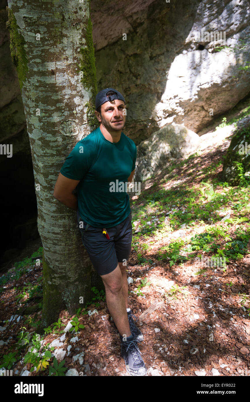 Mature man leaning against tree hi-res stock photography and images - Alamy