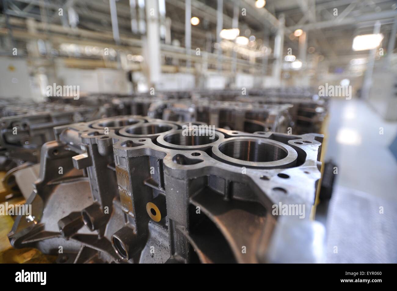 Inside a modern car factory, vehicles and parts move through the ...