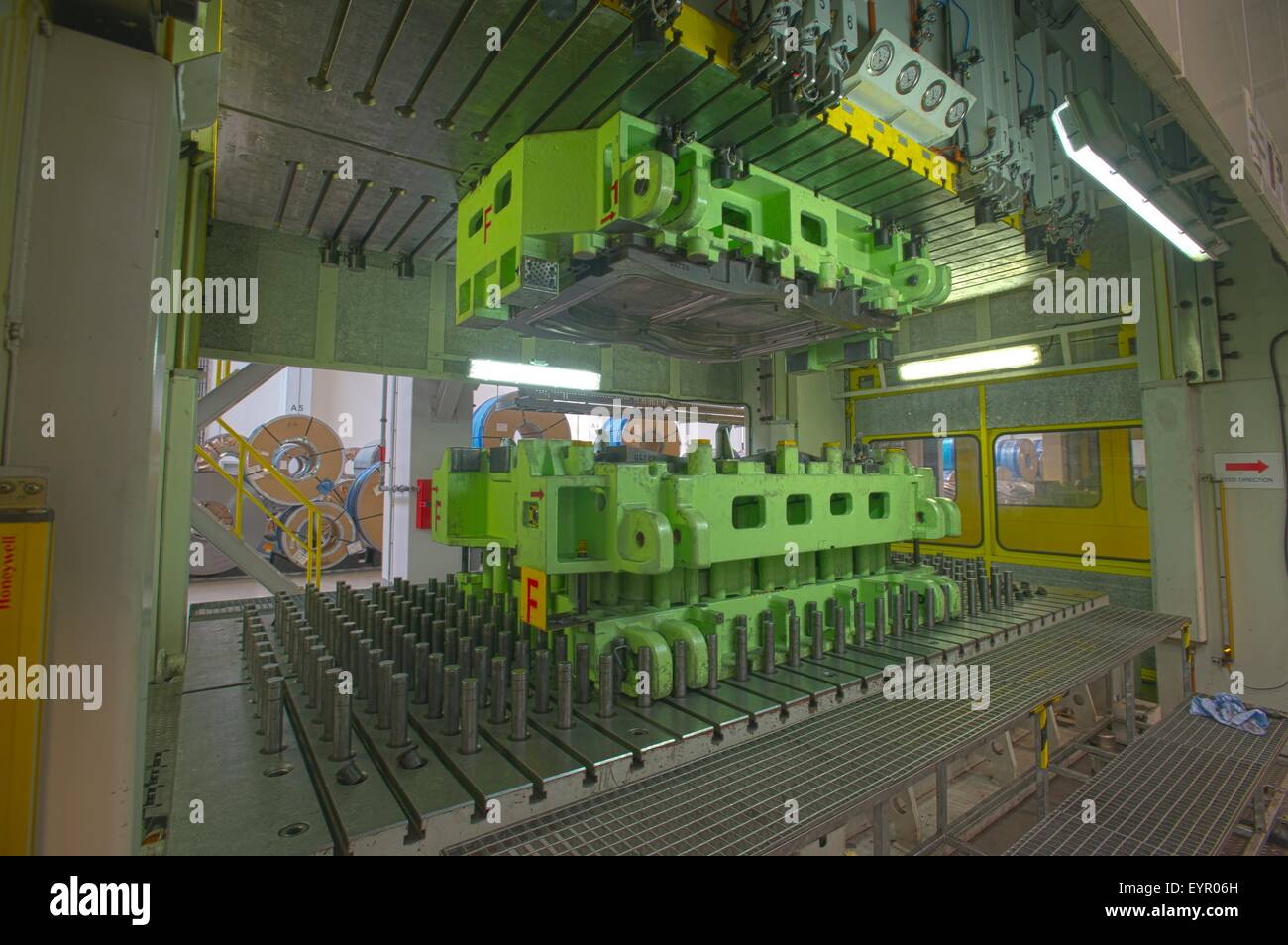Inside a modern car factory, vehicles and parts move through the ...