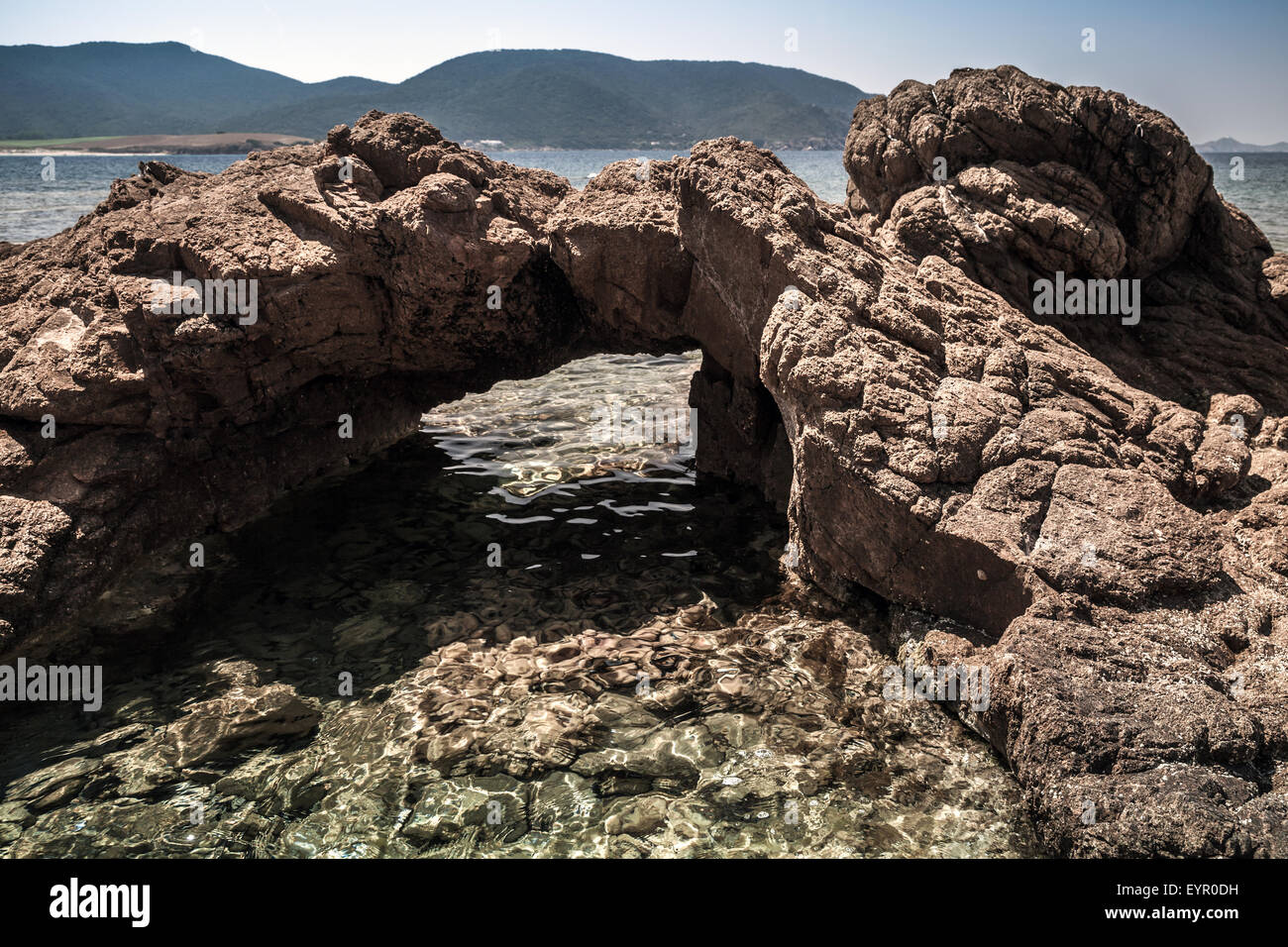 Natural stone grotto on the Mediterranean coast, South Corsica, France ...