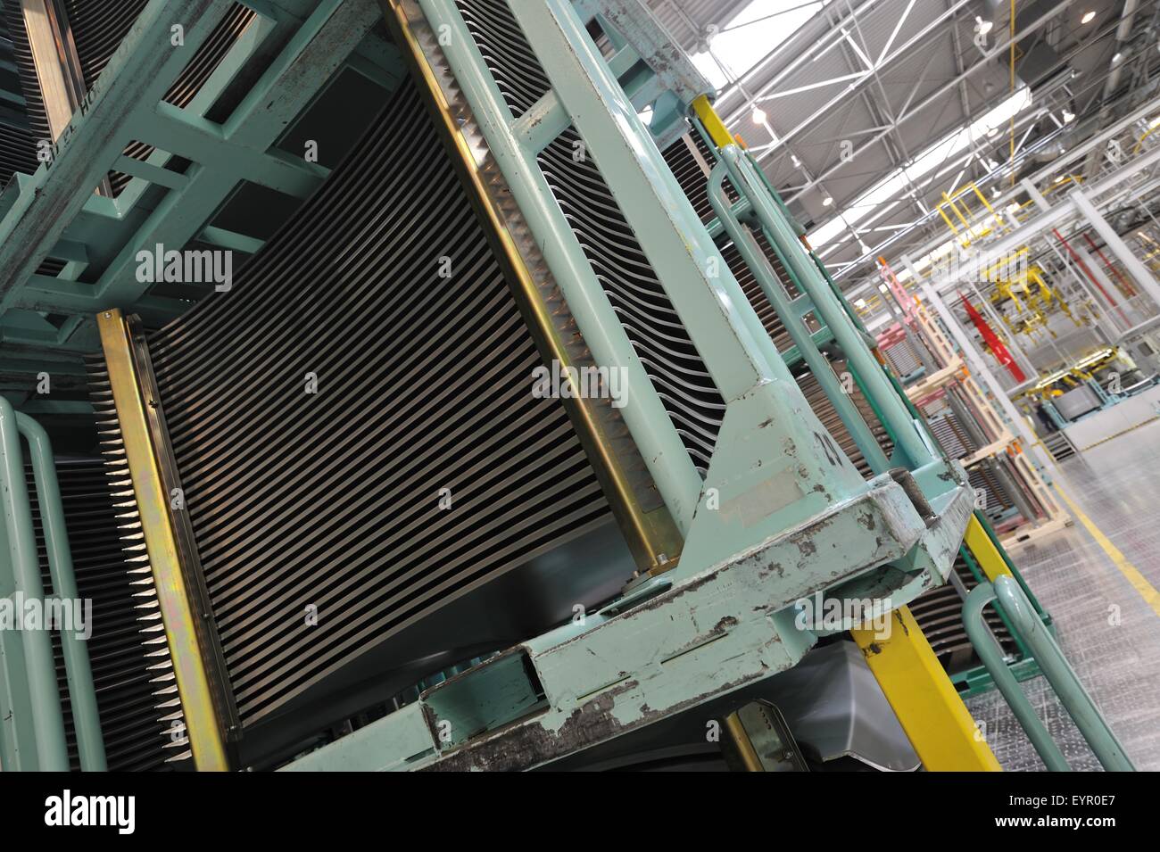 Inside a modern car factory, vehicles and parts move through the ...