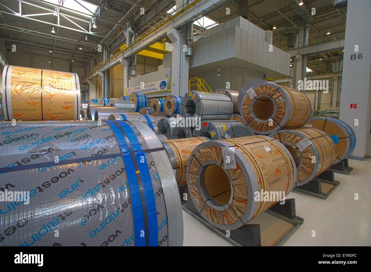 Inside a modern car factory, vehicles and parts move through the ...