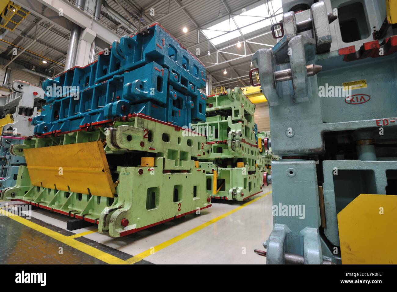 Inside a modern car factory, vehicles and parts move through the ...