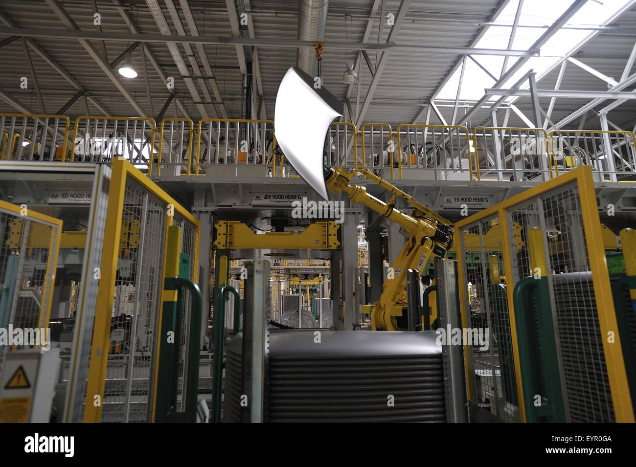 Inside a modern car factory, vehicles and parts move through the ...