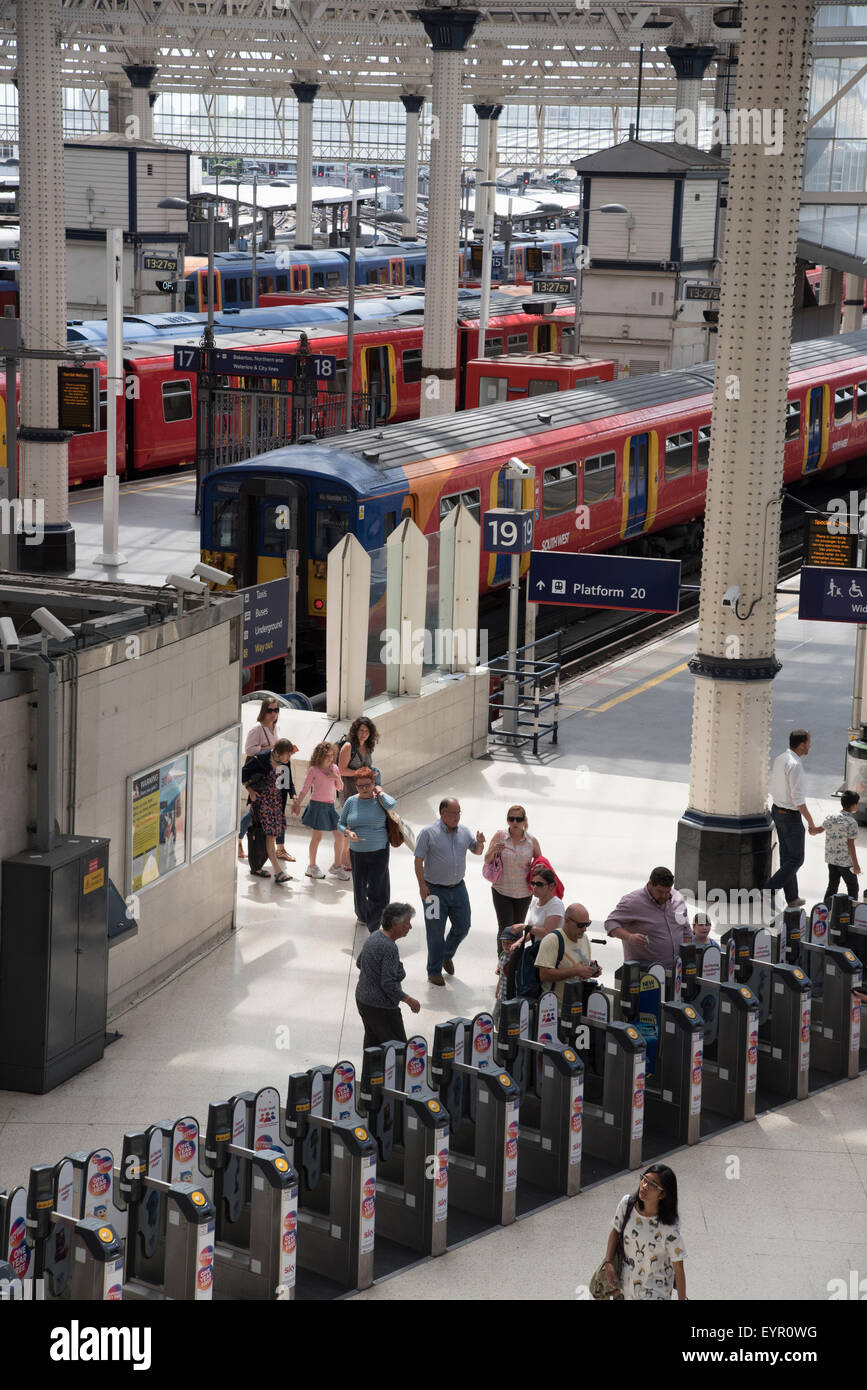 Trains at Waterloo Station central London UK and platform exit barriers ...