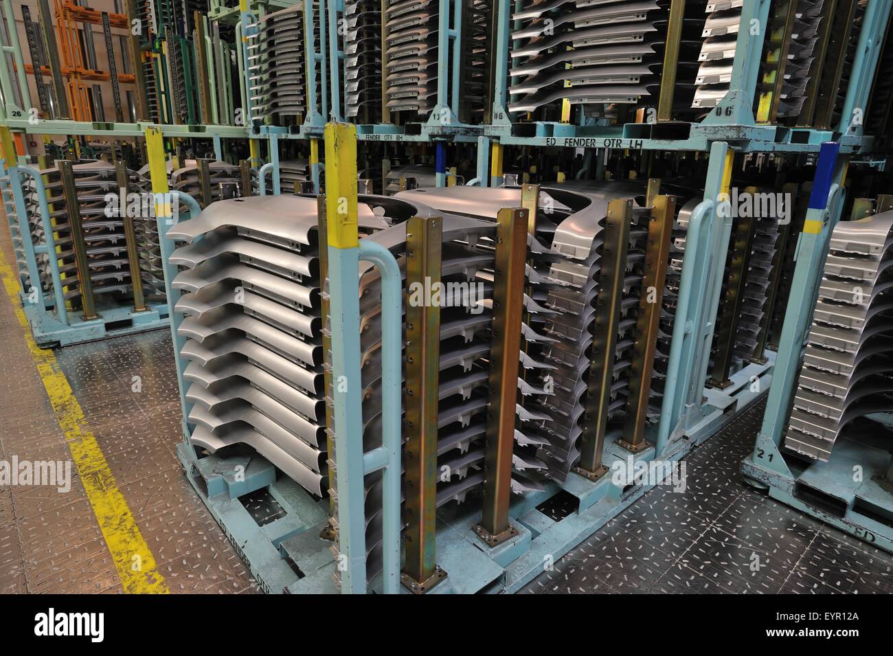 Inside a modern car factory, vehicles and parts move through the ...