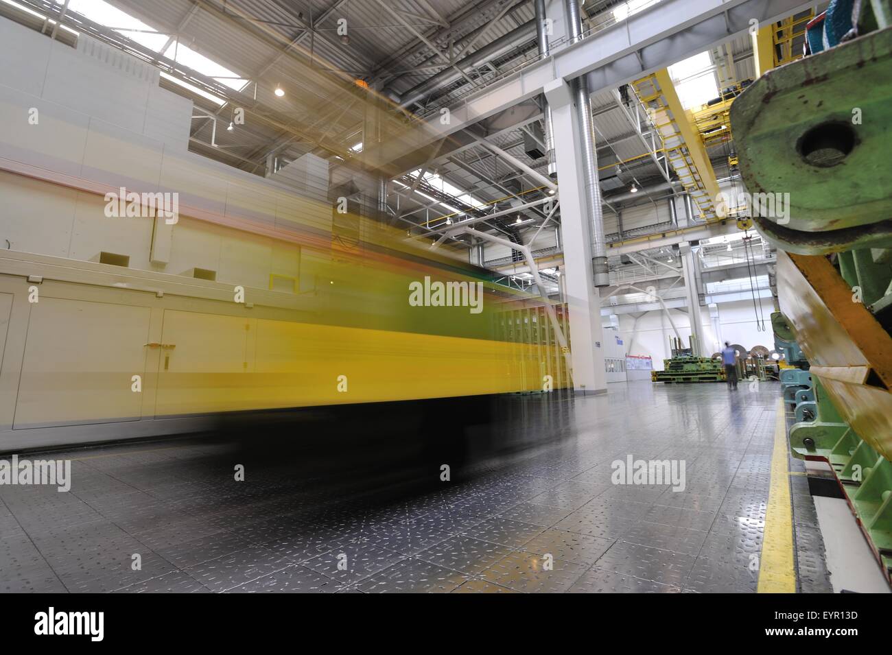 Inside a modern car factory, vehicles and parts move through the ...