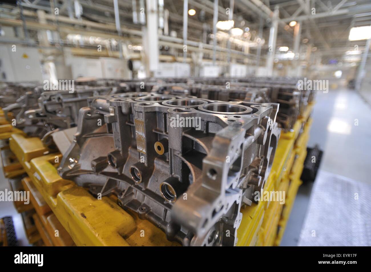 Inside a modern car factory, vehicles and parts move through the ...